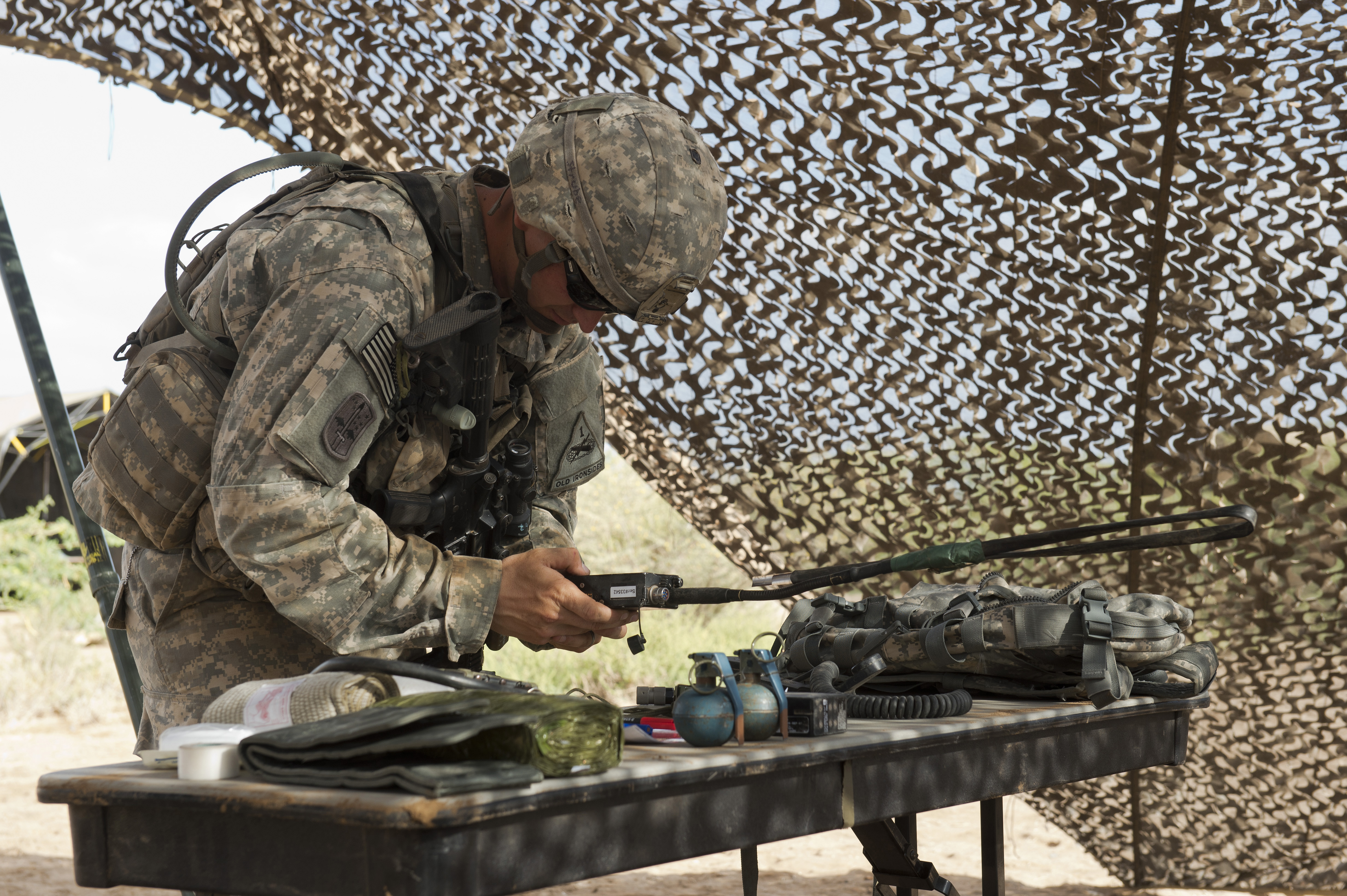 1st Battalion, 77th Armor Regiment Soldier, checks his Radio after ...